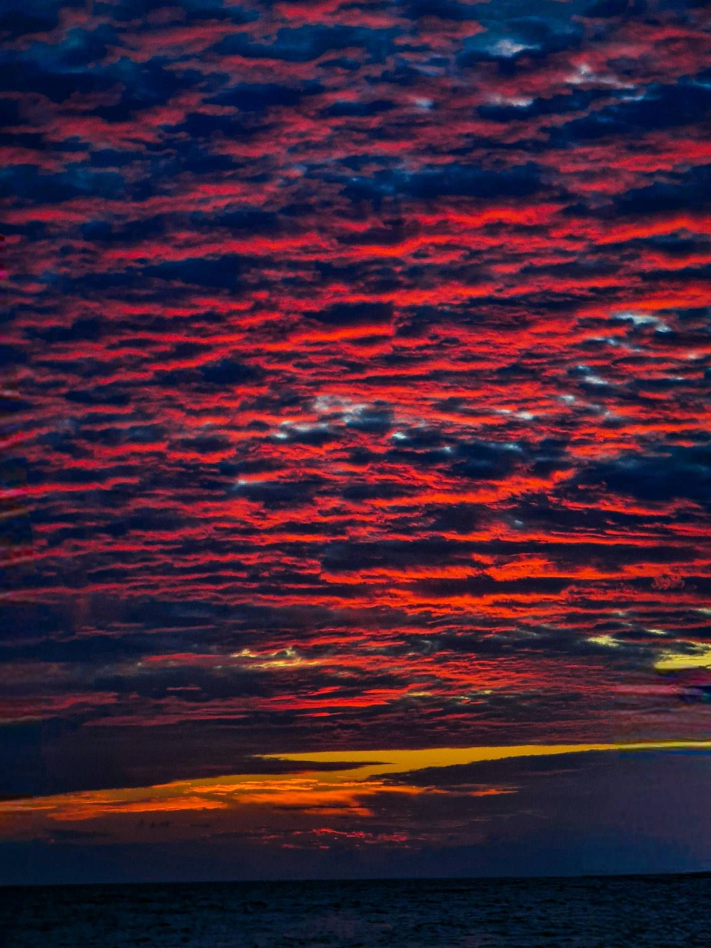 Blood red clouds over a calm blue ocean. Terrifyin... - Samsung Members